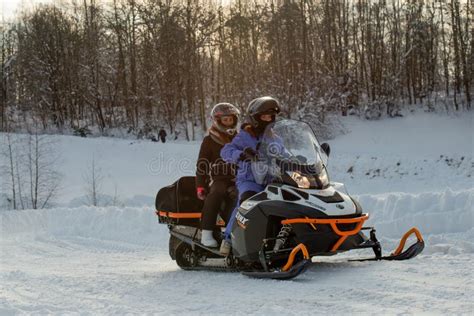 Man Driving A Snowmobile On A Background Of The Vast Expanses Of