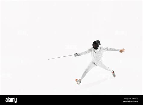 Young Skilled Fencer In Full Gear In Attacking Pose With One Arm