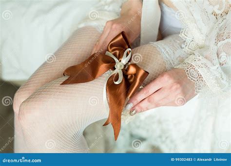The Bride Corrects The Wedding Garter Stock Image Image Of Dress