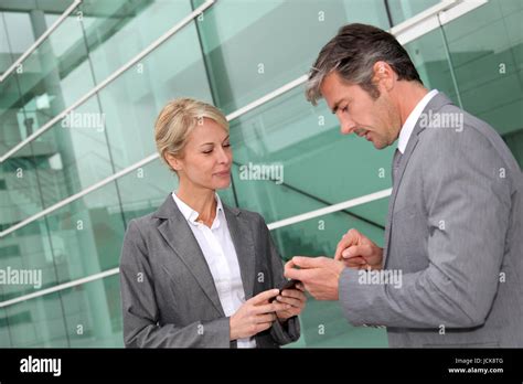 Business People Exchanging Phone Numbers Stock Photo Alamy