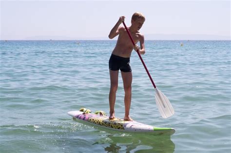 Premium Photo Full Length Of Shirtless Man Standing In Sea Against