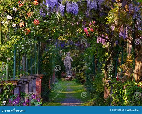 Floral Passage Way With A Statue In The Background Stock Image Image