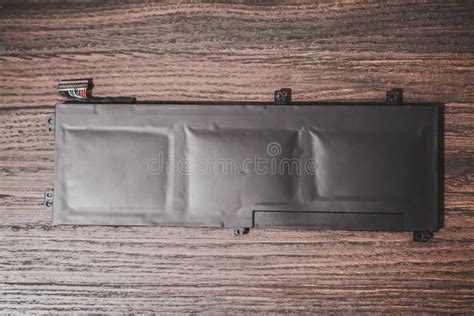Swollen Lithium Polymer Li Po Laptop Battery On A Wooden Table Known Issue For Modern Laptop