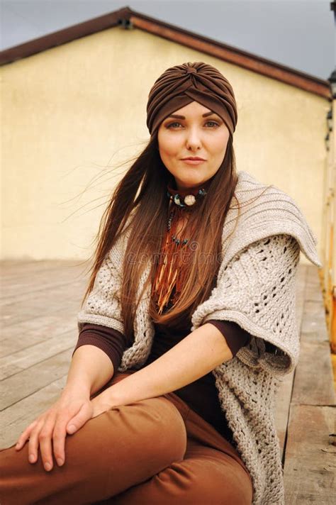 Fashion Portrait Of A Beautiful Smiling Brunette Woman Sitting In Front