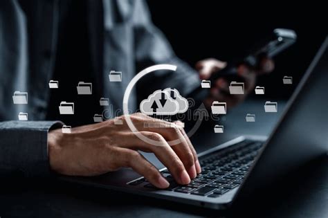 Businessman Using Smartphone And Laptop Uploading To Cloud Computing To