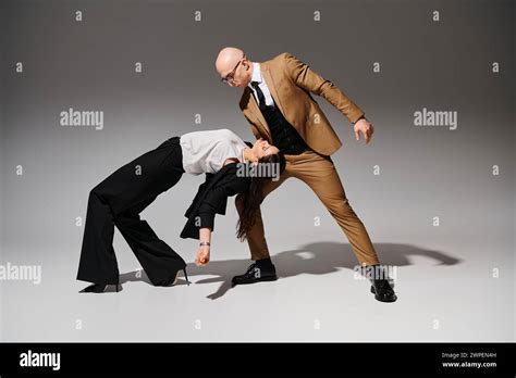 Business Partners In A Coordinated Dance Move Suited Up Together In