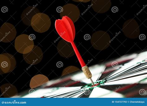 Red Arrow Hitting Target On Dart Board Against Blurred Stock Photo Image Of Market Bokeh