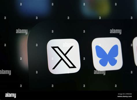 A Close Up Of An Iphone Screen Displaying The X Twitter App Icon And The Bluesky App Icon