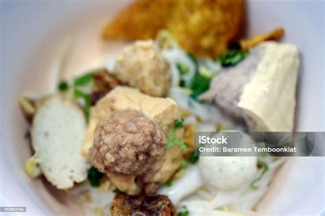 중국 음식 Hakka 국수 돼지 공 생선 공 새우 공 튀김된 Wontons와 함께 토 핑 흰 그릇에 튀긴 두 부 Scallion