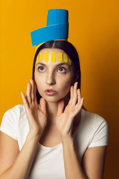 Premium Photo Portrait Of A Woman On A Yellow Background With A