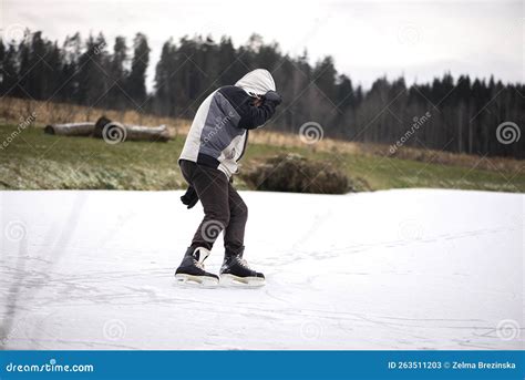 Middle Aged Man In Casual Clothing Ice Skating Outdoors On A Lake Stock