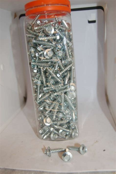 Nails Screws And Fasteners Plastic Container Full Of Bolt Head Self Tapping Screws 5 Mm By 25