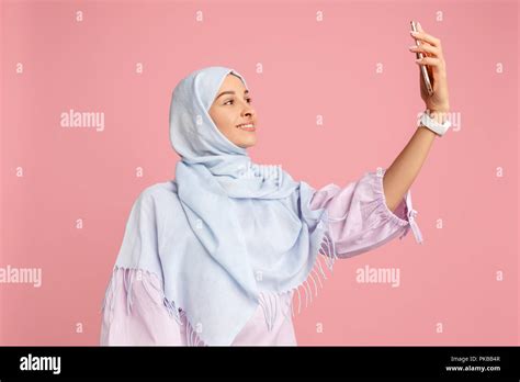 Happy Arab Woman In Hijab With Mobile Phone Making Selfie Portrait Of