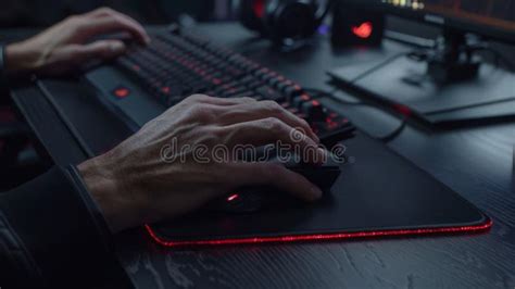 A Closeup Of A Players Hands On His Keyboard And Mouse Skillfully