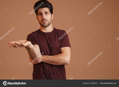 Confused Masculine Man Gesturing Looking Camera Isolated Beige Background Stock Photo