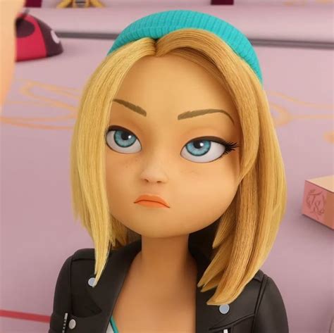 A Close Up Of A Doll With Blonde Hair And Blue Eyes Wearing A Black Jacket