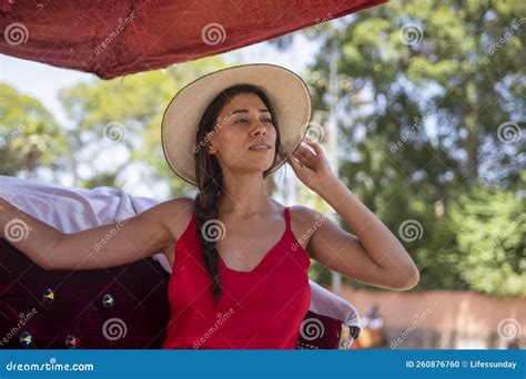 Tourist Woman With A Hat And Red Dress In A Carriage In The Arab City