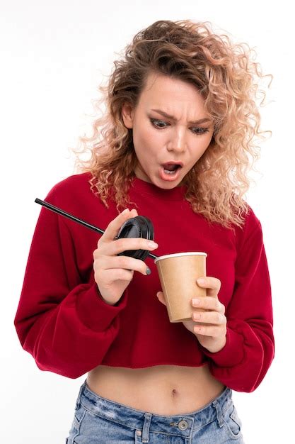 Premium Photo Caucasian Girl With Curly Fair Hair Drinks Coffe And Is