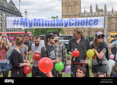 People Hold Balloons Full Of Nitrous Oxide Ready For The Mass