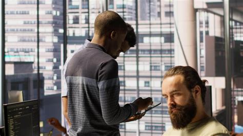 Technician And Colleague Using Device For Managing Cloud Computing Platforms Training Machine