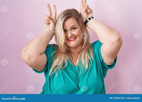 Caucasian Plus Size Woman Standing Over Pink Background Posing Funny