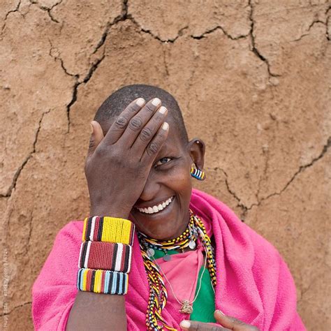 Portrait Of Maasai Woman Smiling Into The Camera By Stocksy
