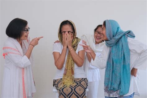 Premium Photo A Woman Covers Her Face And Laughs Because Her Sister