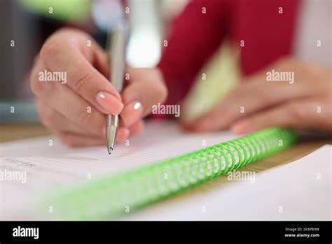 Female Hand Holding Pen And Write Something In Notepad Stock Photo Alamy