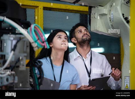 Technicians Are Introducing Industrial Hand Robots To Businessperson Of