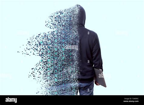 Back View Of Man In Hood Hacker With Laptop Dispersing And Disintegrating Into Particles Of The