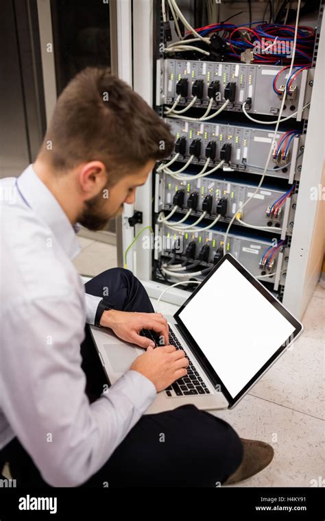 Technician Using Laptop While Analyzing Server Stock Photo Alamy