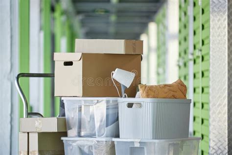 Cart Loaded With Stack Of Boxes Storing Personal Possessions In Self Storage Warehouse Stock