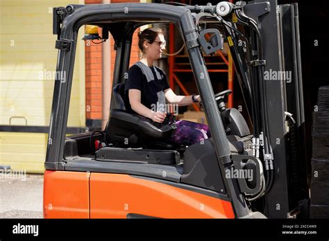 Woman 20 30 Operating Forklift In Industrial Setting Showcasing Skills And Safety In Material