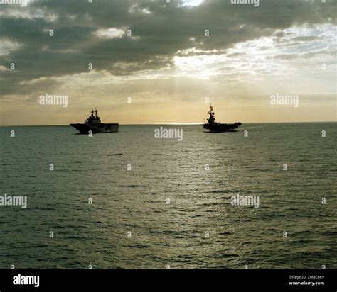 The Aircraft Carrier Uss Coral Sea Cv 43 Right And The Amphibious