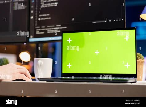 System Administrator Designing And Developing Software Applications Using Green Screen Laptop