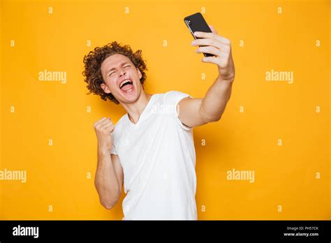 Cheerful Man With Brown Hair Clenching Fist While Taking Selfie On