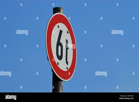 Traffic sign 6t white with red edge in front of blue sky asbackground ...