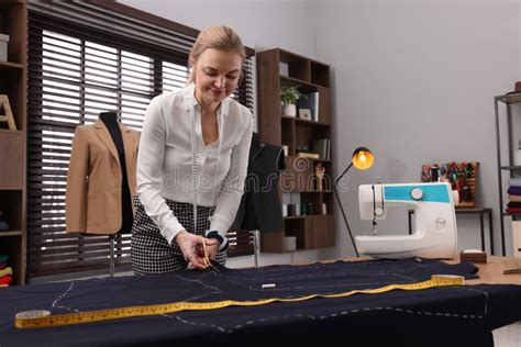 Dressmaker Cutting Fabric By Following Chalked Sewing Pattern In Workshop Stock Image Image Of