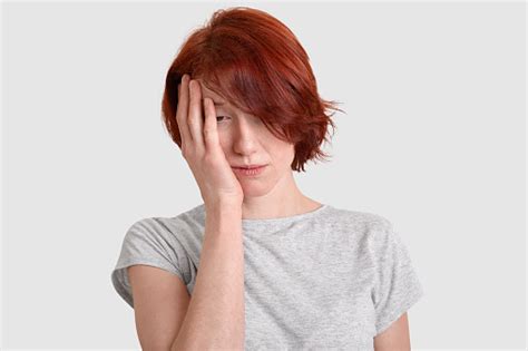 짧은 붉은 머리 졸린 슬픈 여자 우울 불만 입고 흰색 T 셔츠 느낌 지나치게 많은 작업 후 화이트 스튜디오 벽에 고립 된 느낌