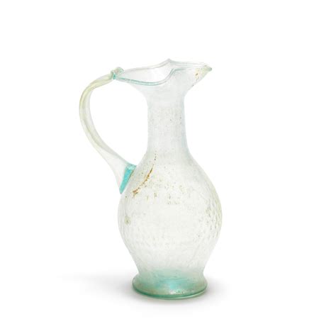 Bonhams A Roman Pale Aquamarine Glass Mould Blown Trefoil Lipped Jug