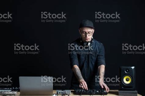 집중 하 고 집중 블랙 모던 하 고 사운드 스튜디오에서 음악을 만드는 전문 Dj 남자 그는 검은 벽에 서 서 텍스트에 대 한 빈
