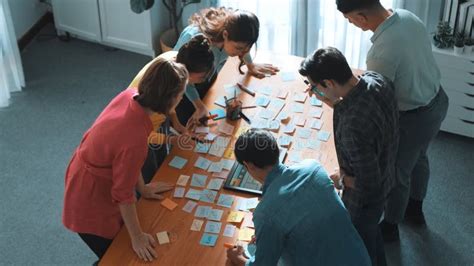 Top View Of Manager Writing Idea On Sticky Notes And Explain Idea