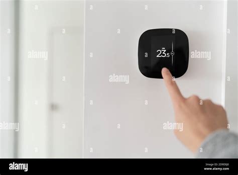 Smart Home Digital Thermostat Touch Screen Woman Touching Touchscreen To Adjust Temperature Of