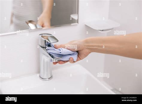 Cleaning The Sink Faucet With A Microfiber Cloth Sanitize Surfaces