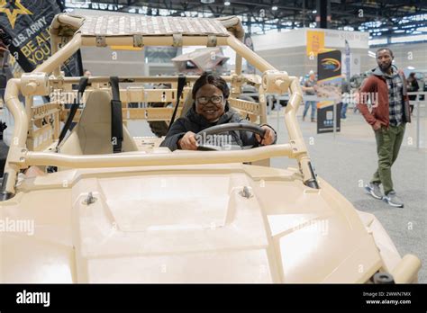 A Spectator Sits In The Polaris Mrzr D2 Pretending To Ride During The Chicago Auto Show At The