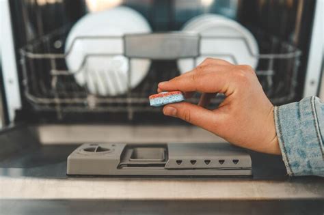 Premium Photo Dishwasher Capsule Dishwasher Tablets Woman Puts The