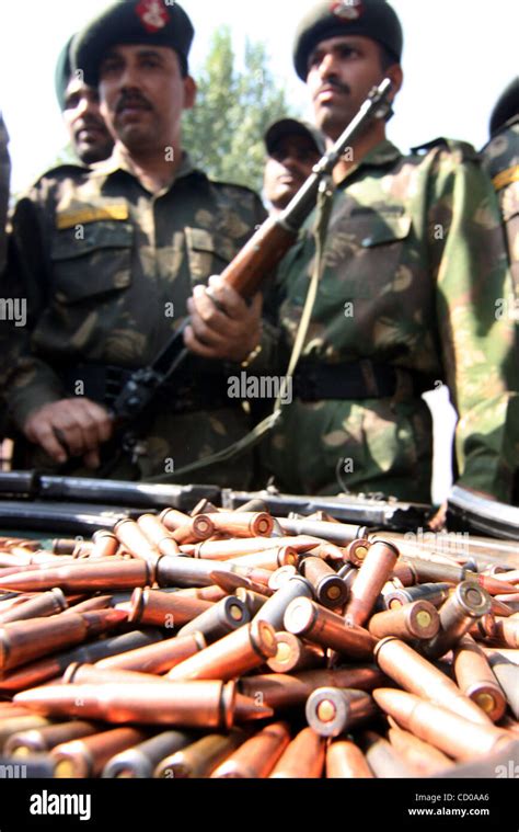 Indian Army Soldiers And Personnel Stand Behind Seized Arms After A