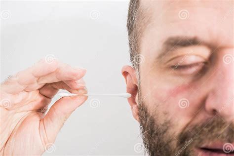 Man Removing Wax From Ear Using Q Tip Stock Image Image Of Cotton