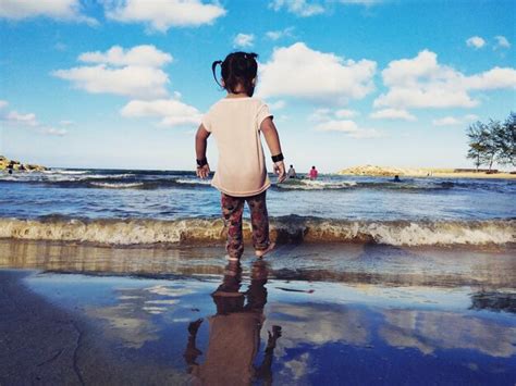 Premium Photo Rear View Of Girl Standing On Beach