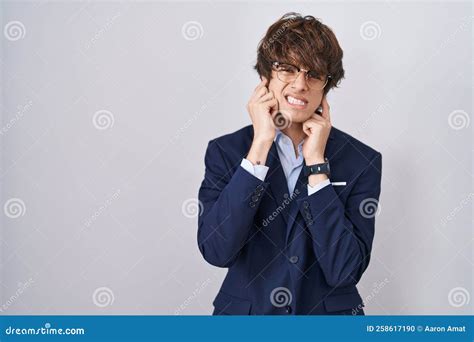 Hispanic Business Young Man Wearing Glasses Covering Ears With Fingers